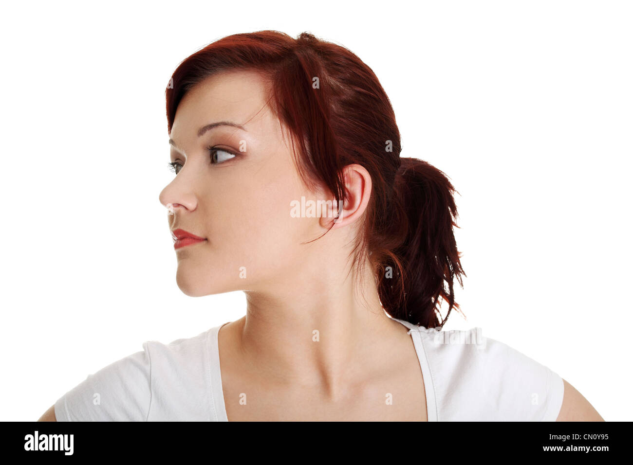 Portrait of a young woman looking left, isolated on white background ...