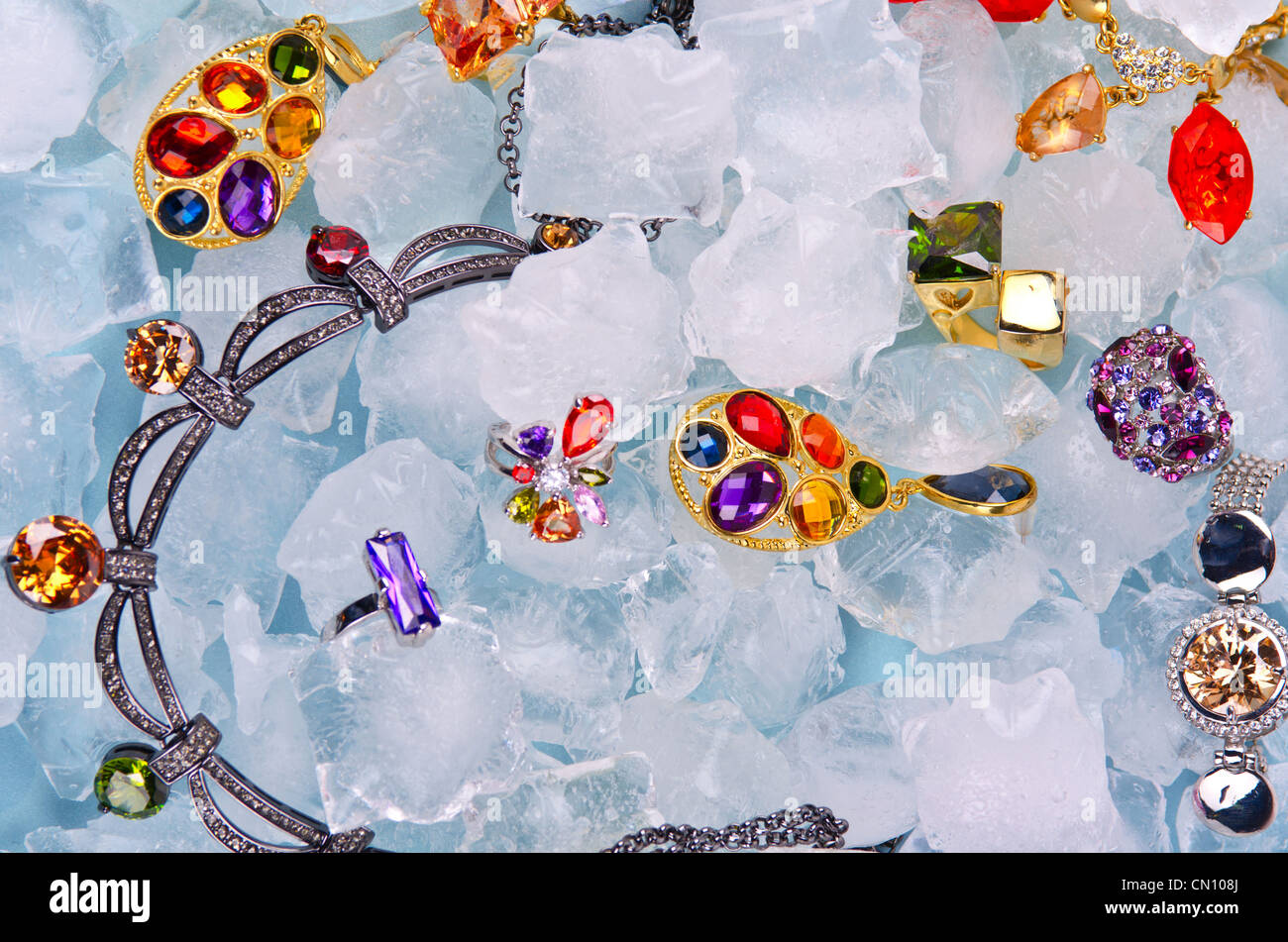 Jewels at blue cube of ice background Stock Photo - Alamy