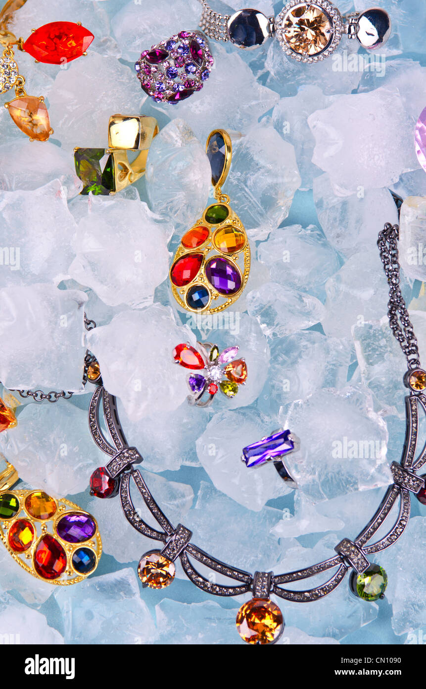 Jewels at blue cube of ice background Stock Photo - Alamy