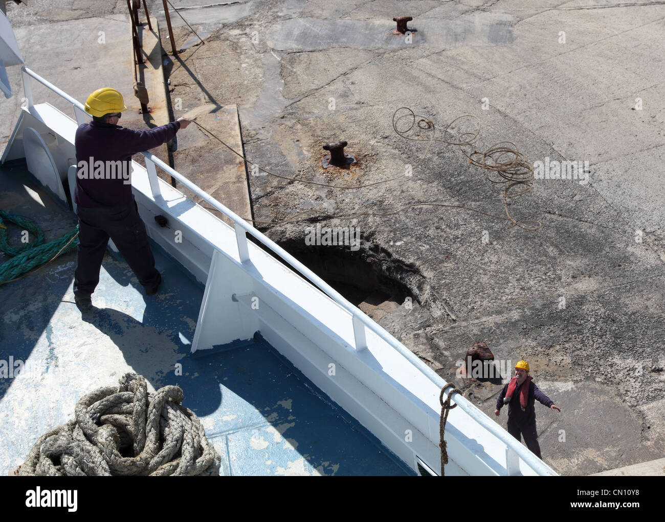 A deckhand on the Maltese ferry Malita throws a mooring rope to a ...