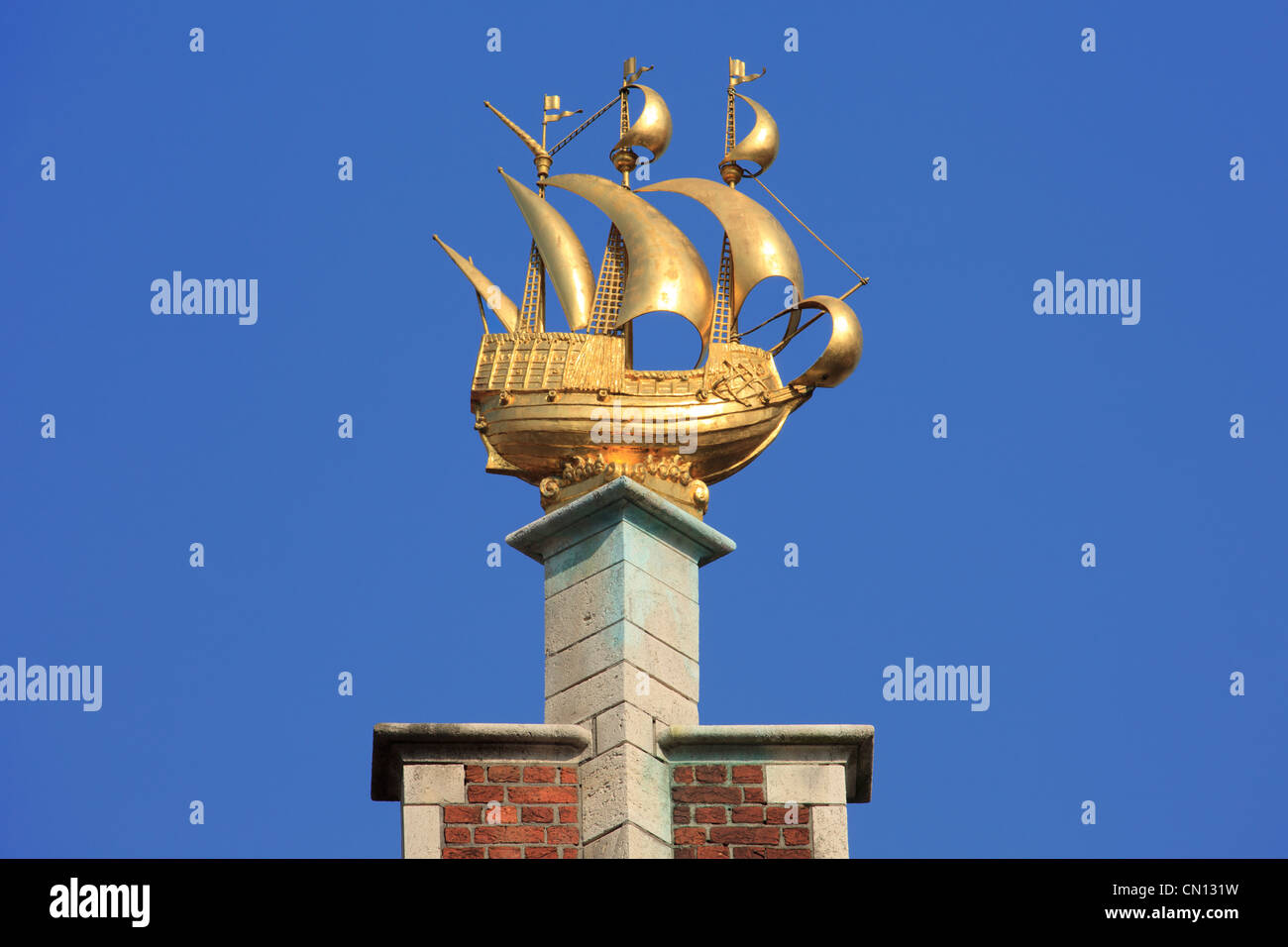 A crow-stepped gable topped by a golden statue of a sailing ship at the ...