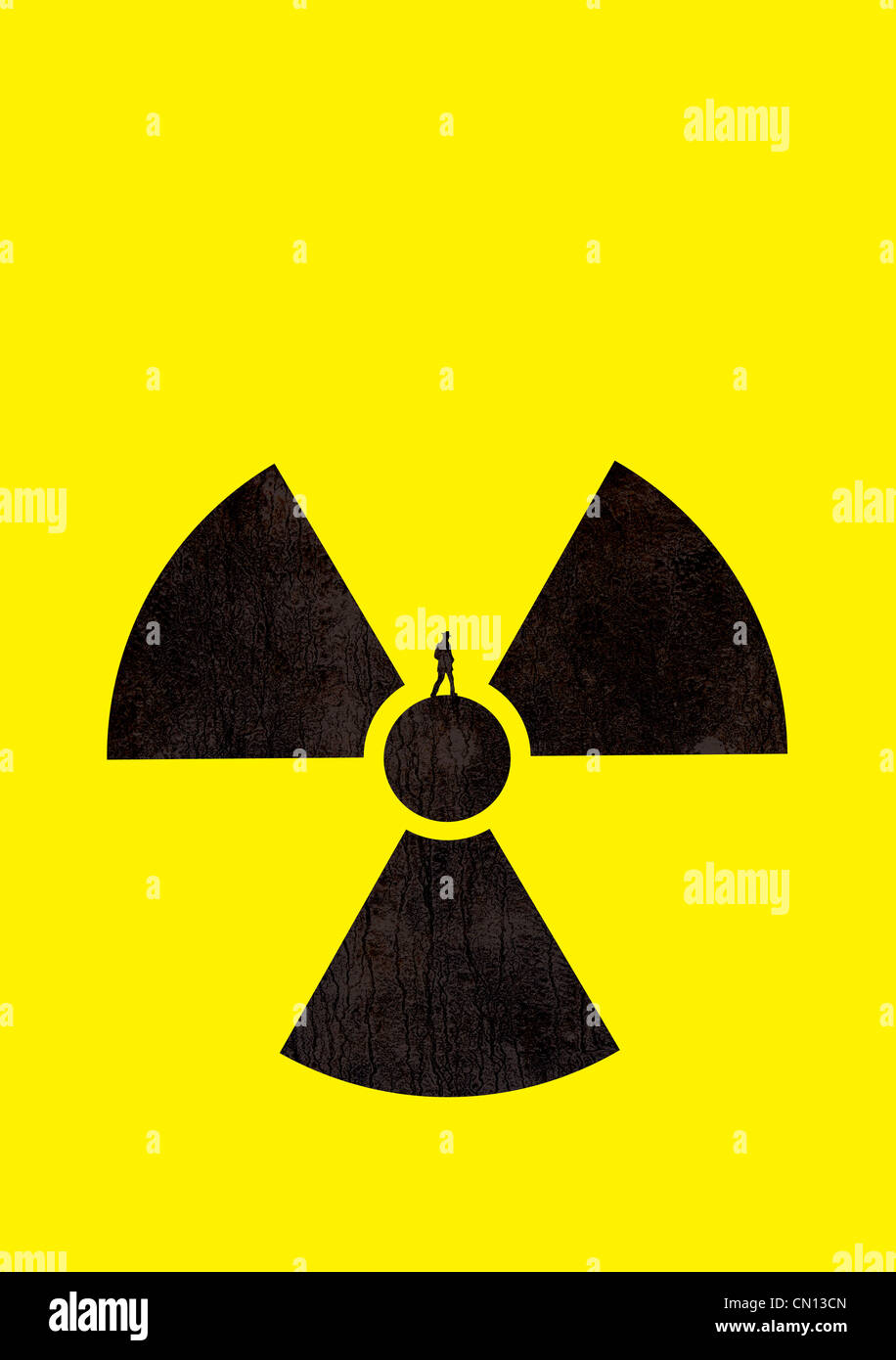 Man standing on a radioactive symbol. The man and symbol are ...