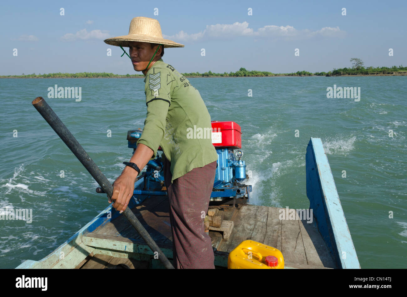 Boat driver on outboard boat. Irrawaddy delta. Myanmar Stock Photo - Alamy