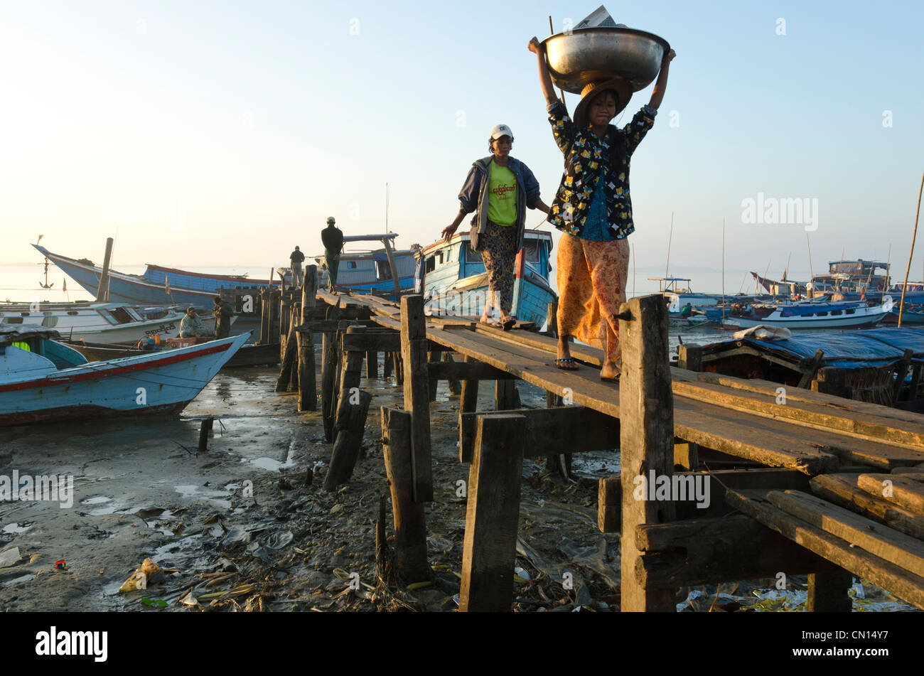 Women at a wooden jetty in Labutta harbour. Irrawaddy delta. Myanmar ...