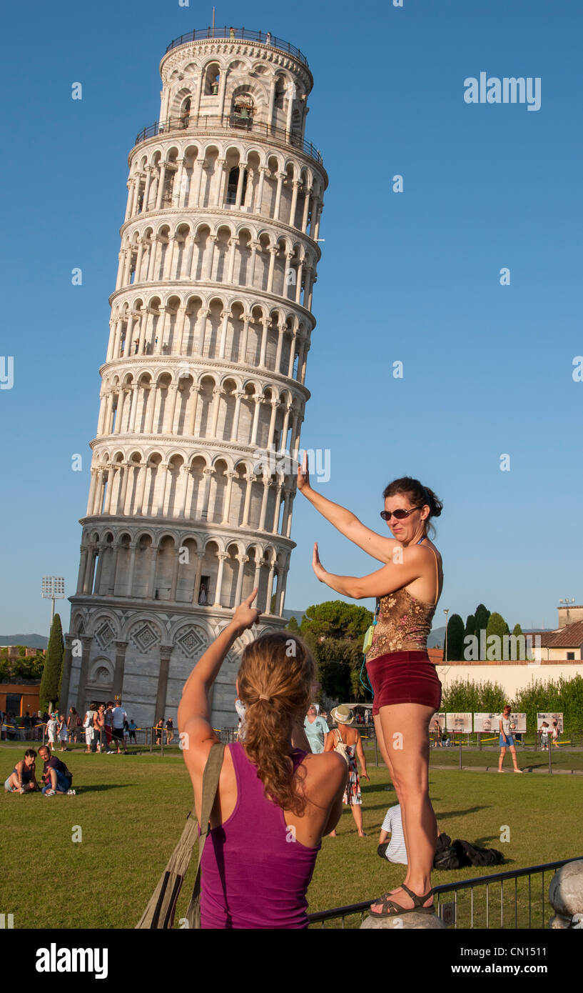 Tourists Pose for Photographs Pretending to Hold Up the Leaning Tower ...