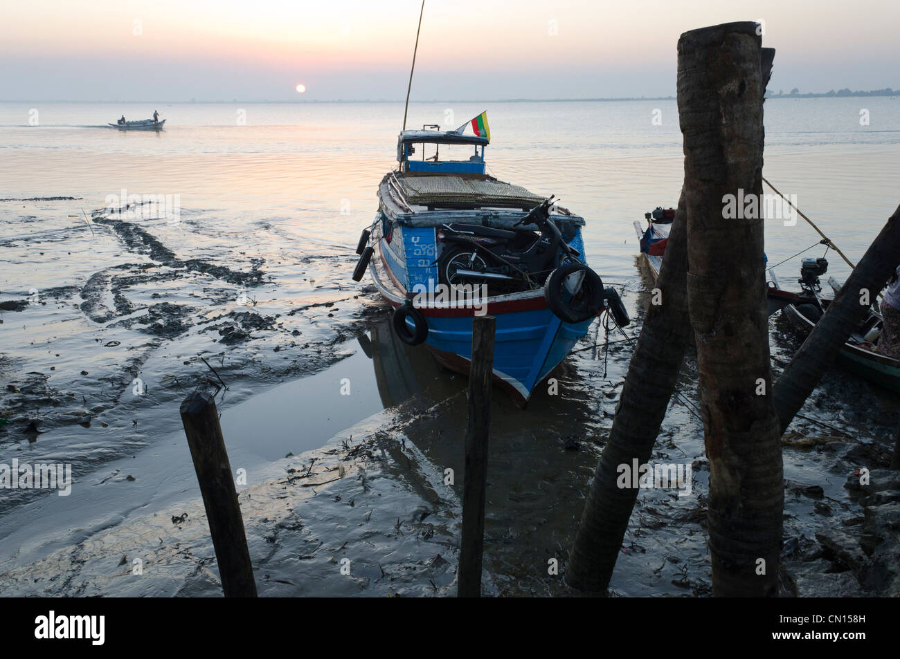 Passenger boat at sunrise in Labutta harbour. Irrawaddy delta. Myanmar ...