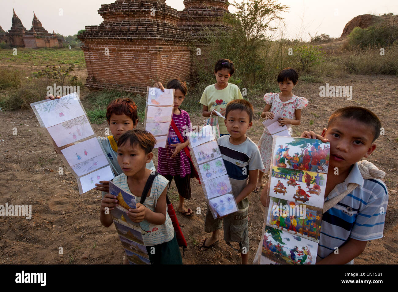 Children selling postcards and begging in Bagan Myanmar Stock Photo - Alamy