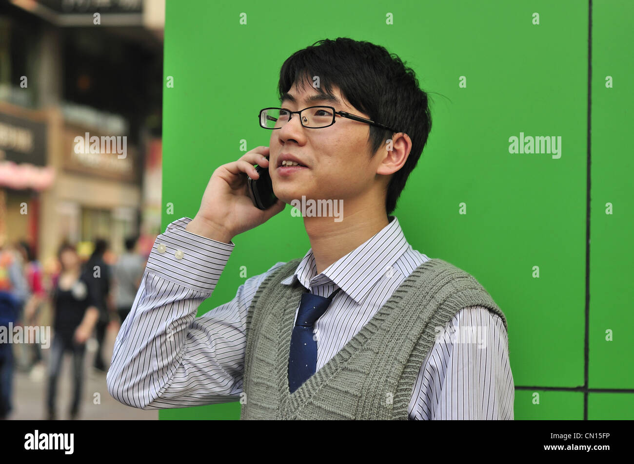 chinese young businessman using mobile phone,outdoors Stock Photo - Alamy
