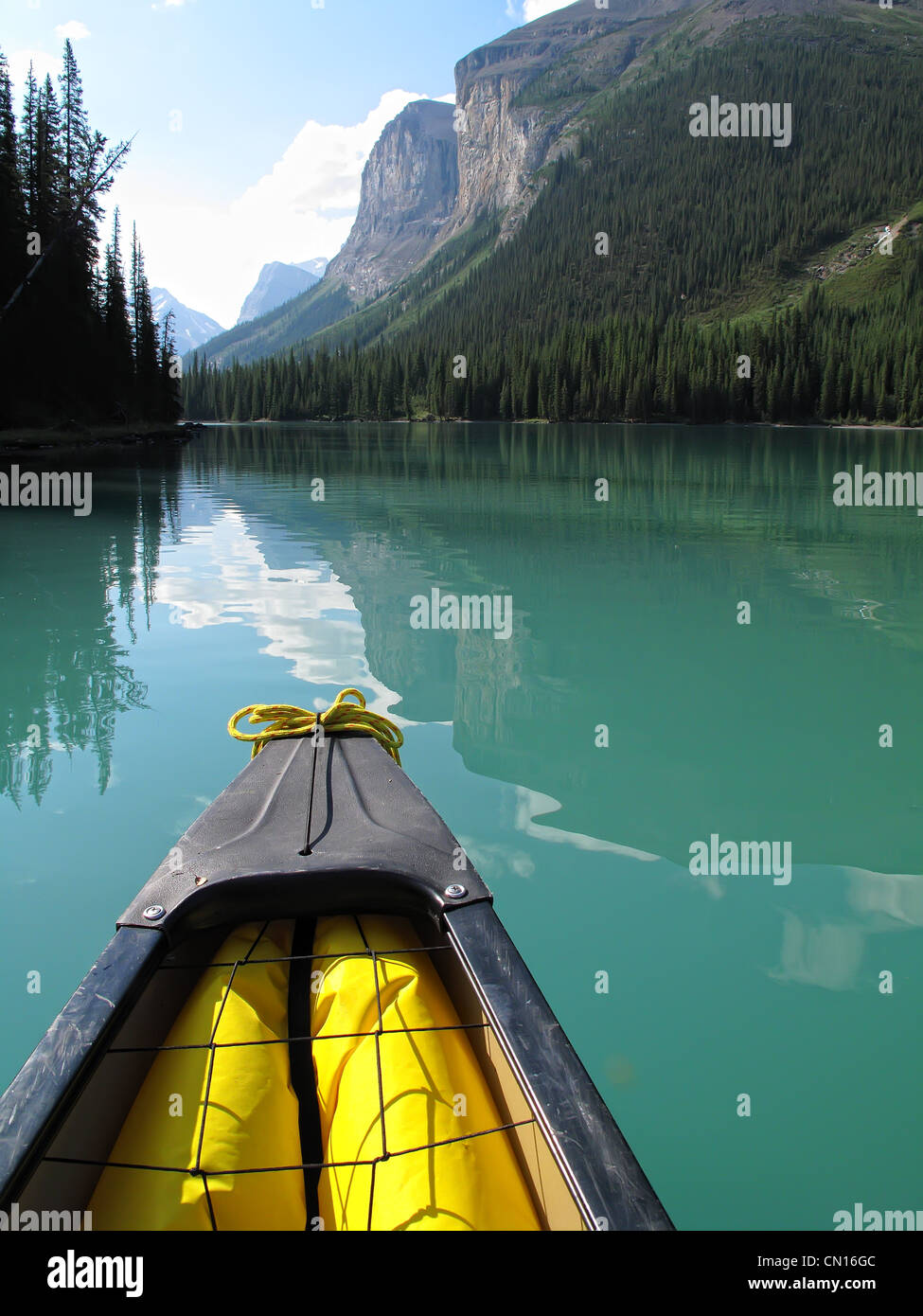 The front of a canoe heading into the Narrows in Maligne Lake, Jasper ...