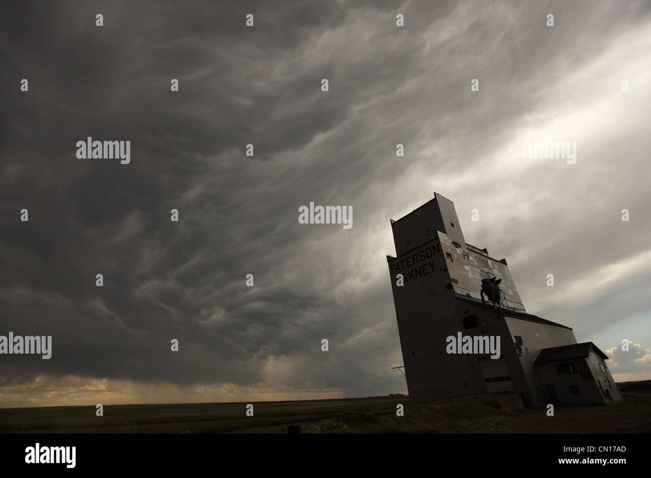 Storm clouds over a grain elevator in rural Saskatchewan Stock Photo ...