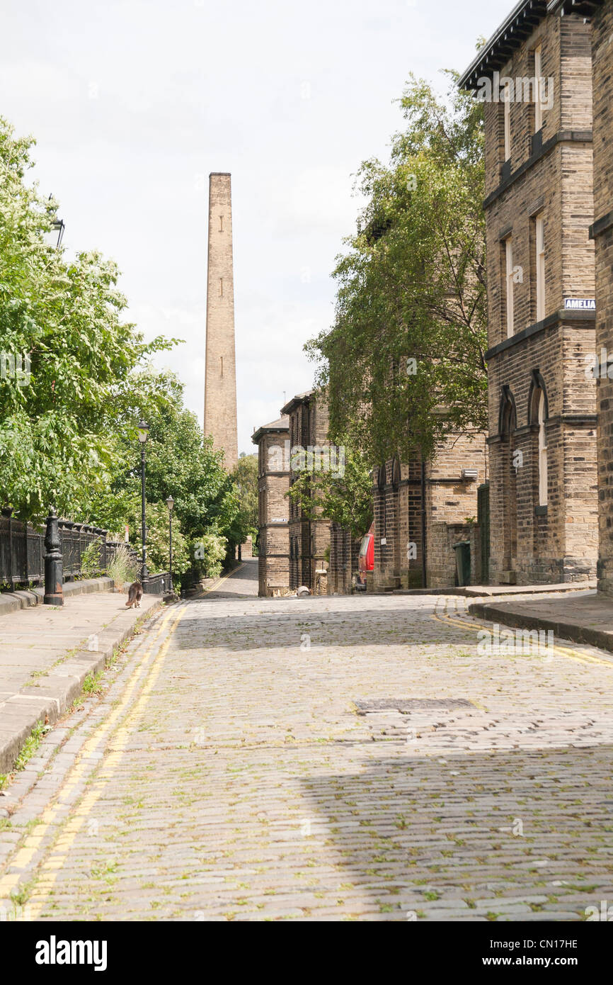 A mill factory chimney and cobbled street at Saltaire, West Yorkshire ...