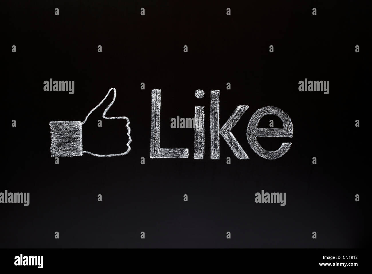 Thumbs up sign with the word Like on a blackboard with white chalk ...