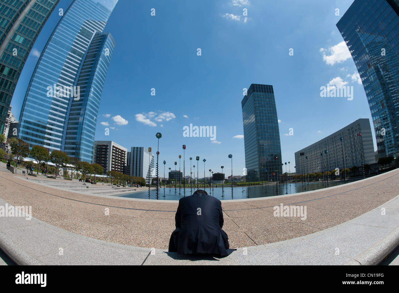 Man sitting on bench tired and lonely in business district feeling ...