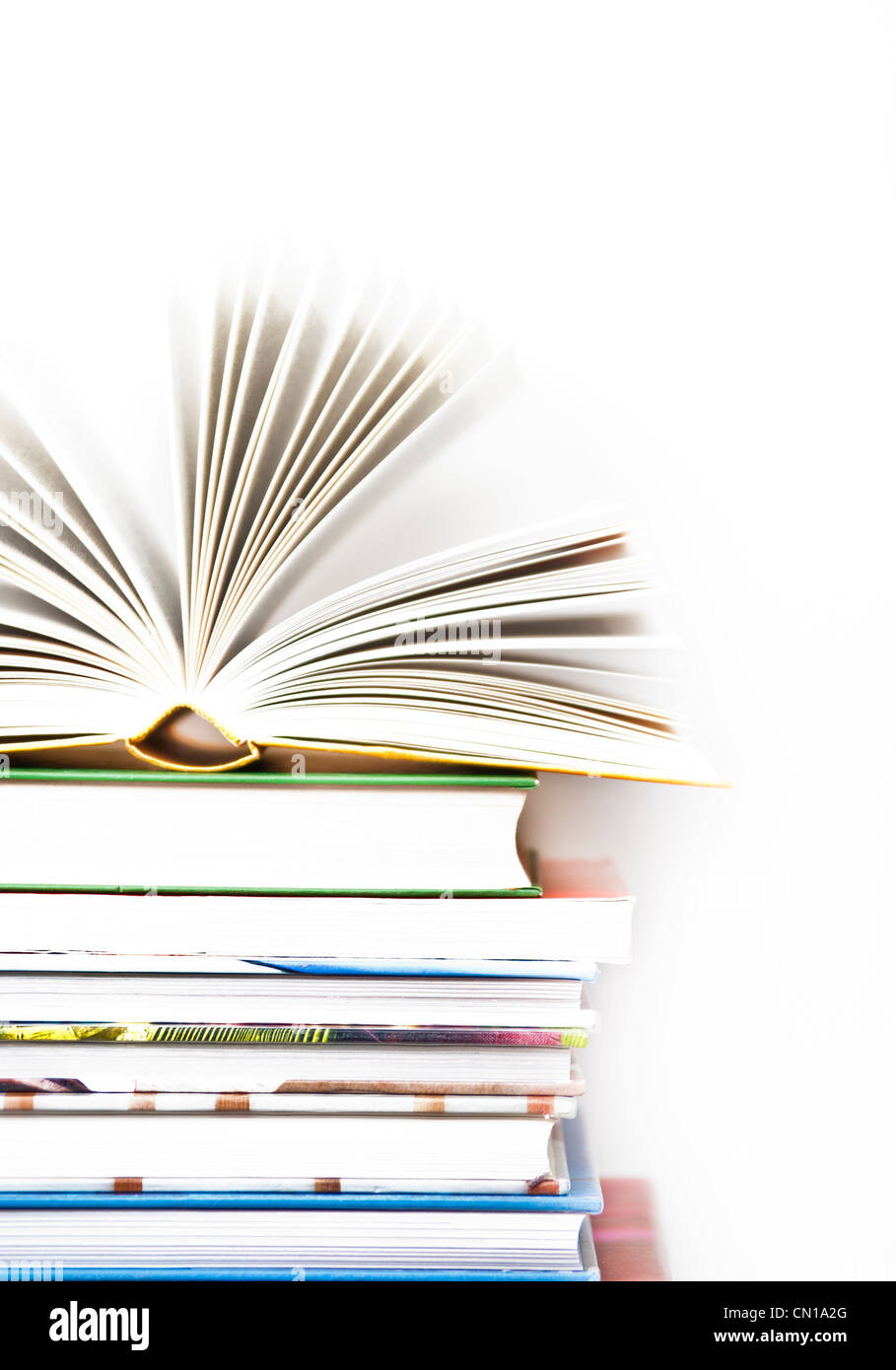 An open book on a stack of books Stock Photo - Alamy