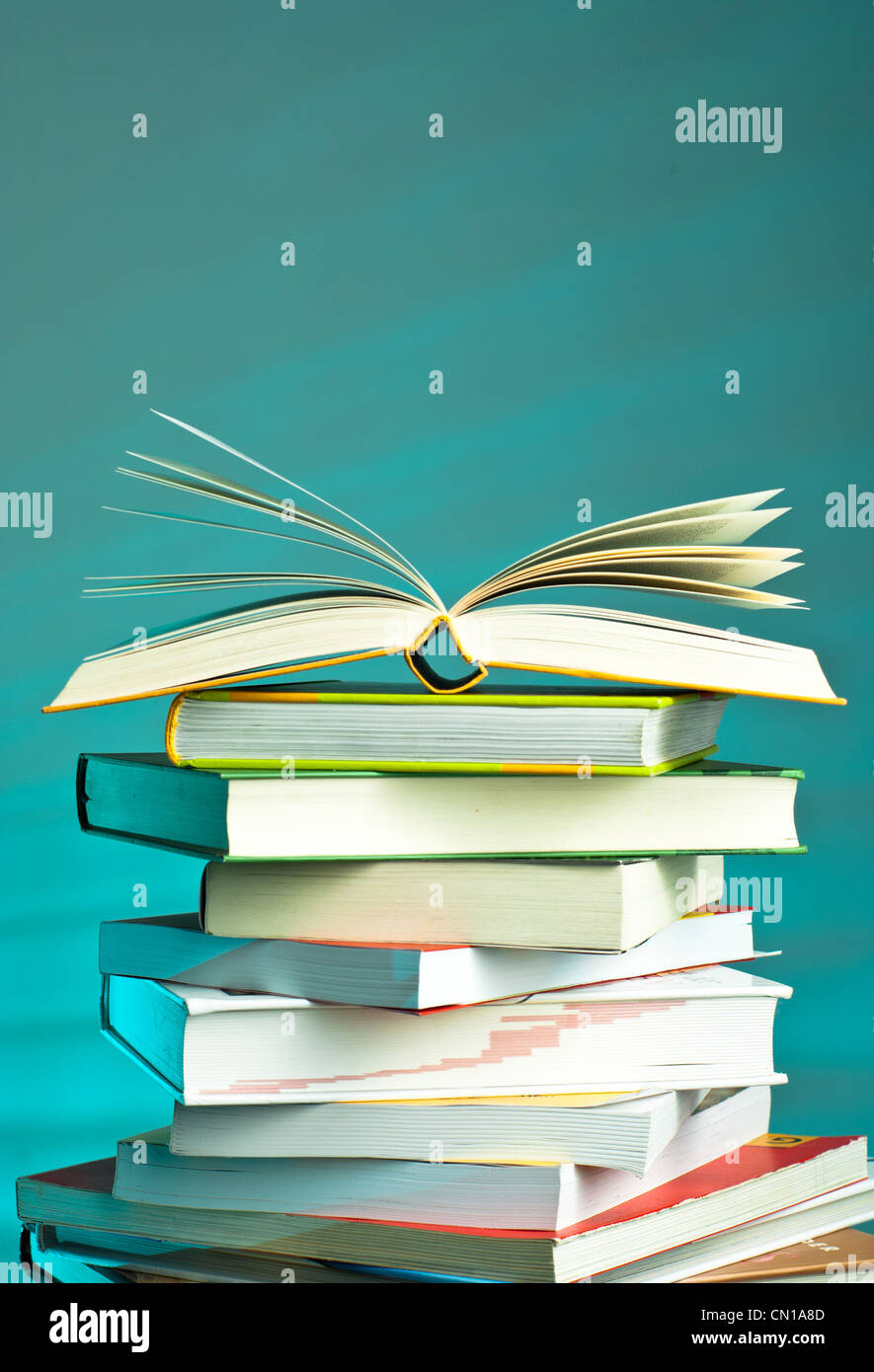 An open book on a stack of books Stock Photo - Alamy