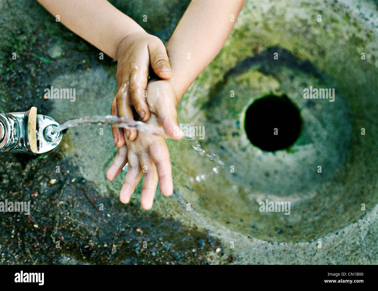 Little boy washing his hands in a fountain at a park, Montreal, Quebec ...