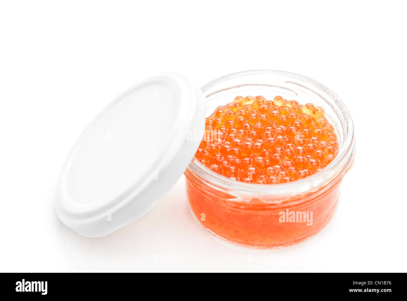A glass jar of red salmon caviar on a white background Stock Photo - Alamy