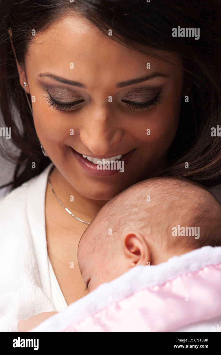 Young Attractive Ethnic Woman Holding Her Newborn Baby Under Dramatic ...