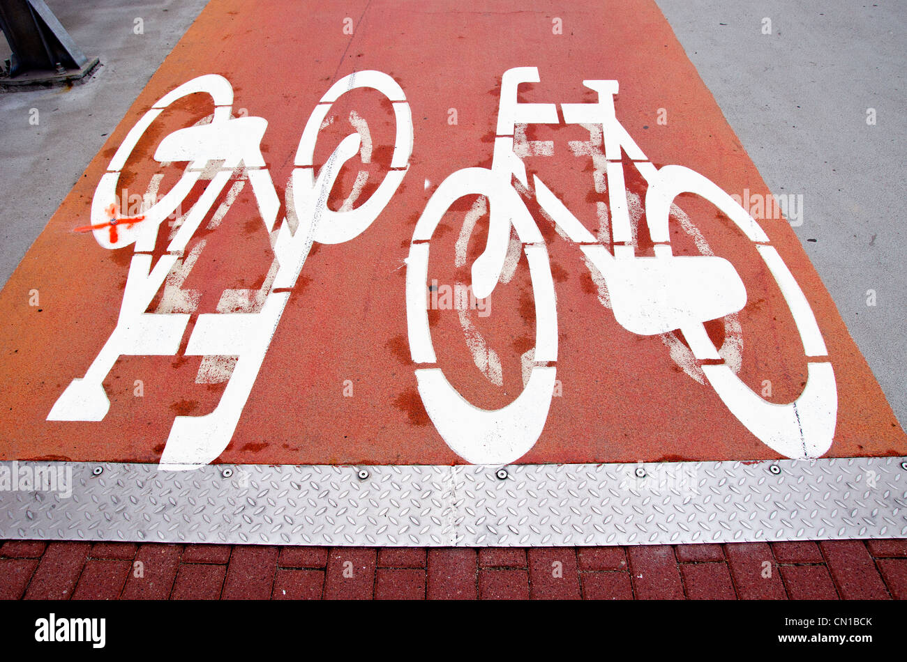 bicycle track signs on pavement in the city Stock Photo - Alamy