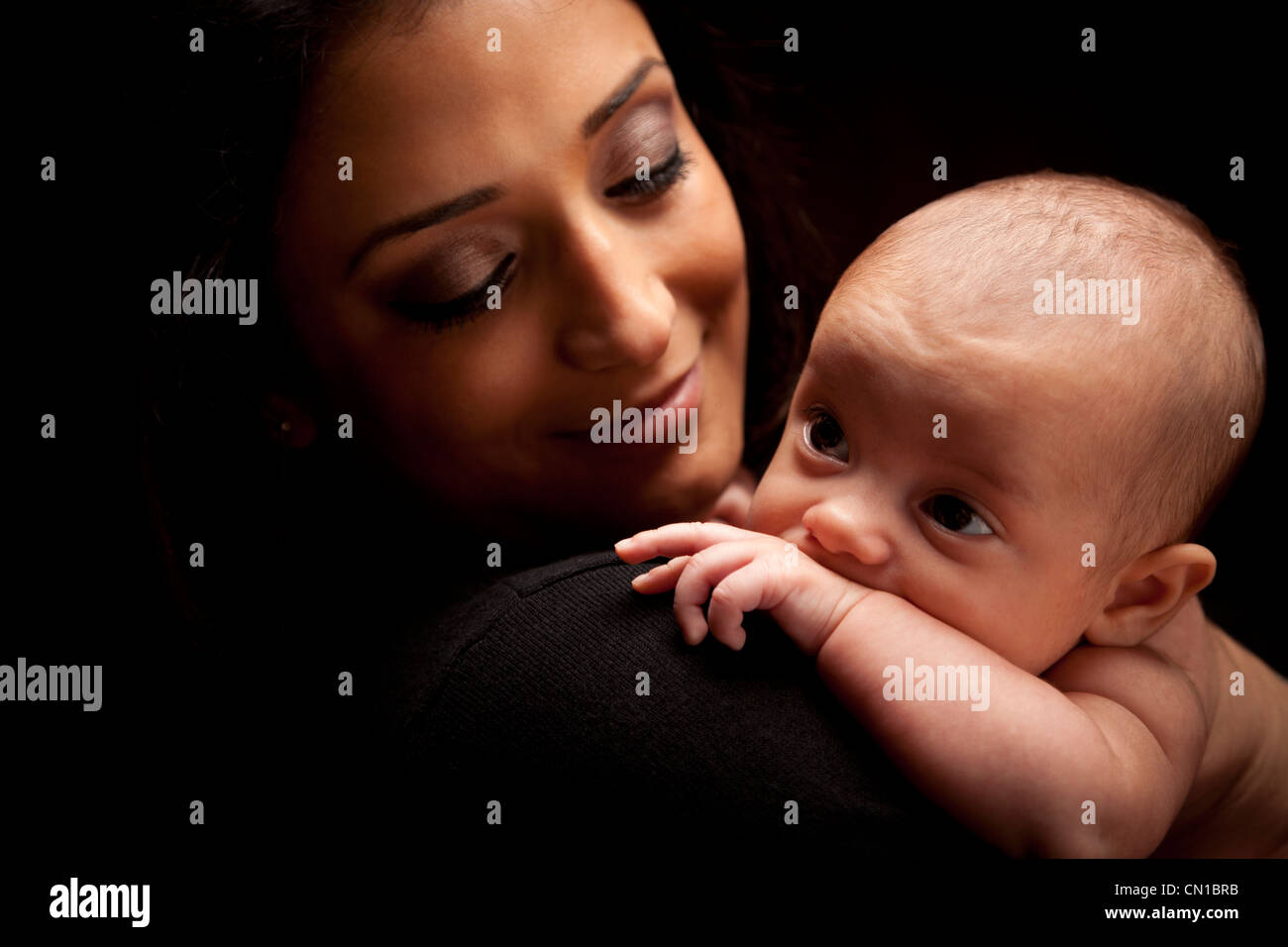 Young Attractive Ethnic Woman Holding Her Newborn Baby Under Dramatic ...