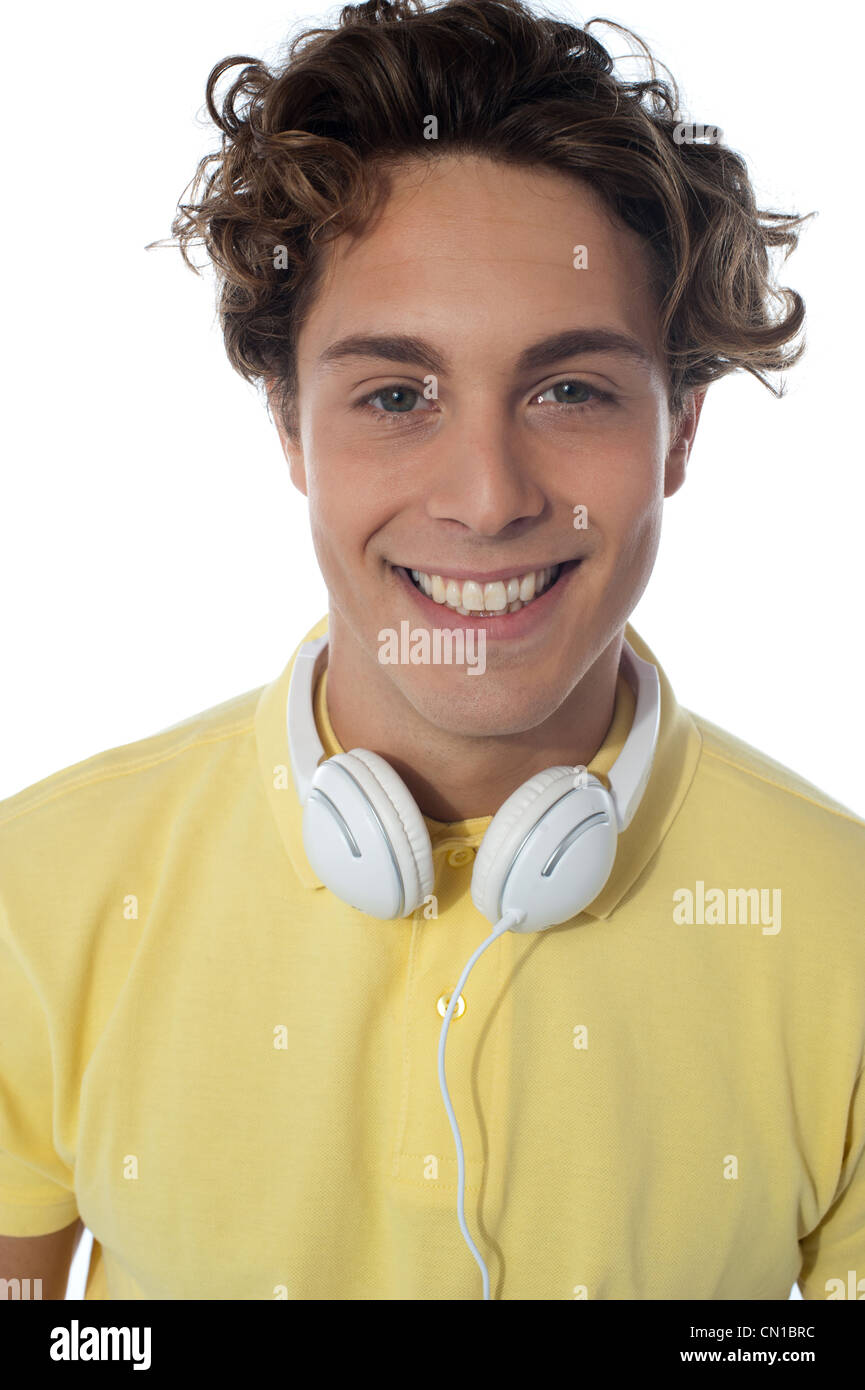 Guy with headsets around his neck smiling at you, close-up portrait ...