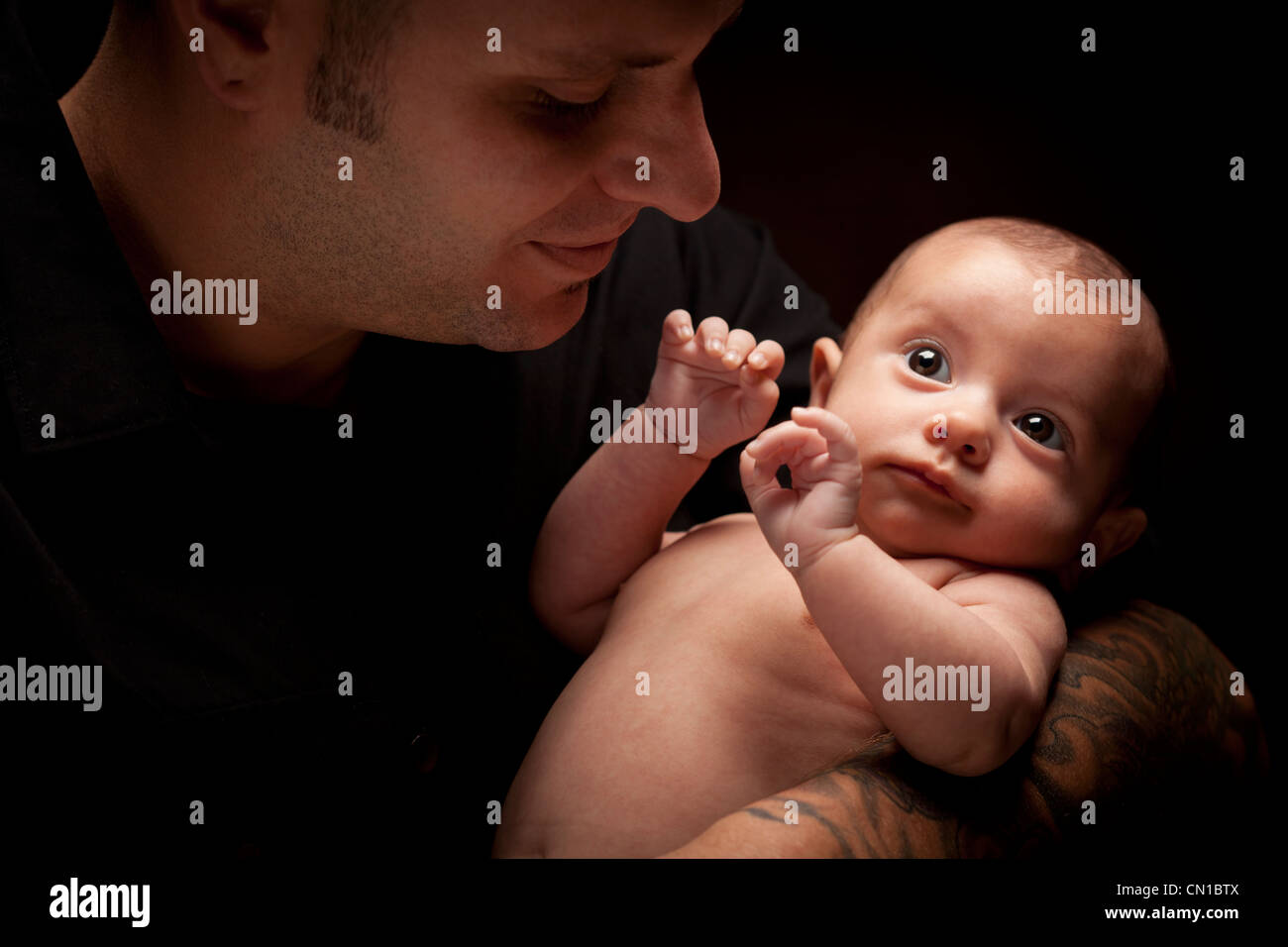 Happy Young Father Holding His Mixed Race Newborn Baby Under Dramatic ...
