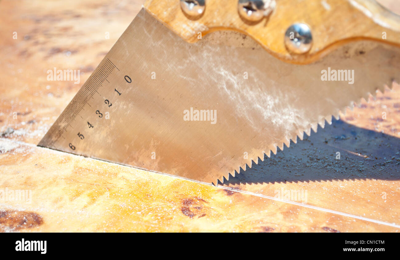 Saw cutting wood board Stock Photo - Alamy