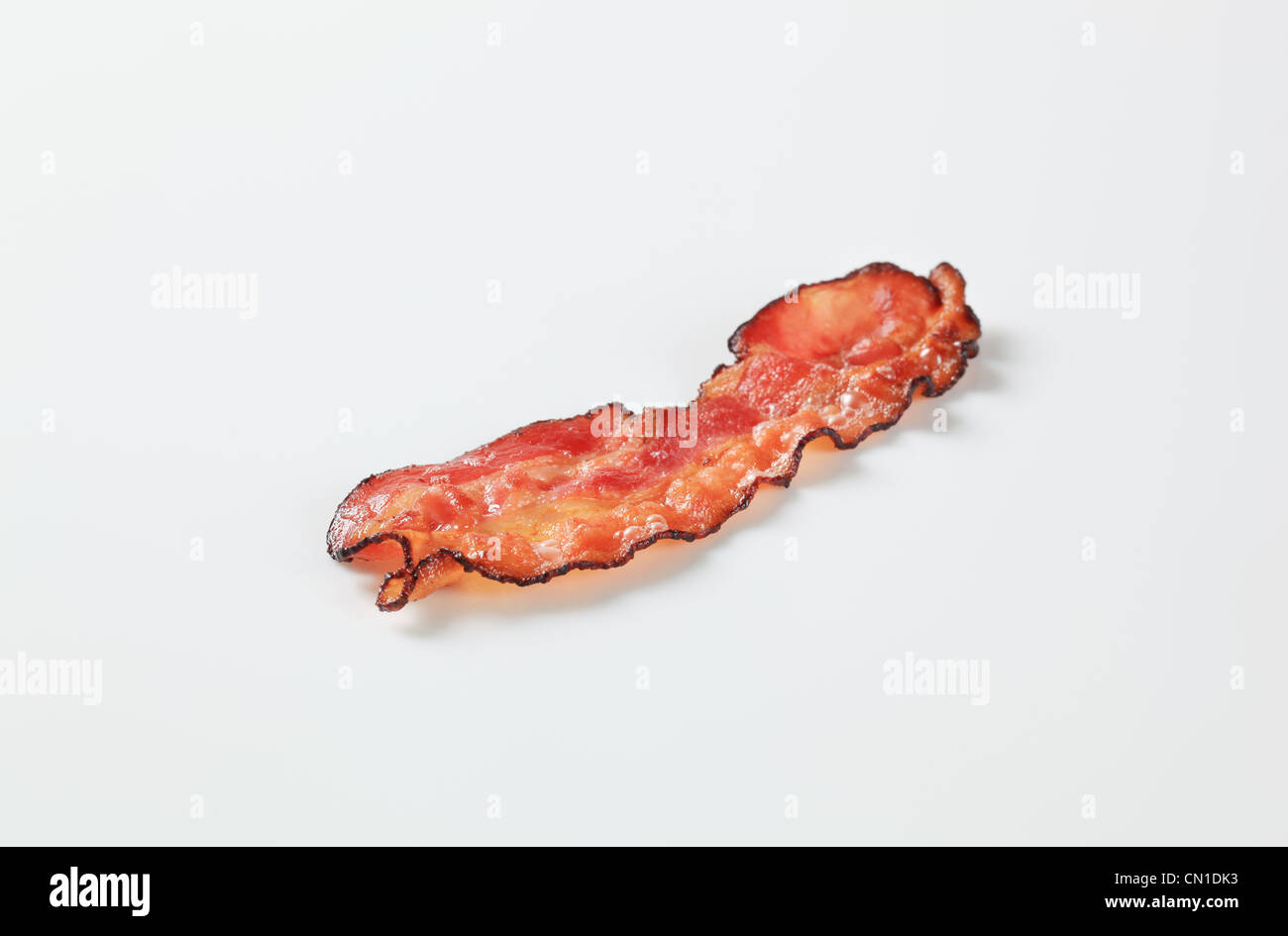 Crispy pan-fried strip of bacon Stock Photo - Alamy