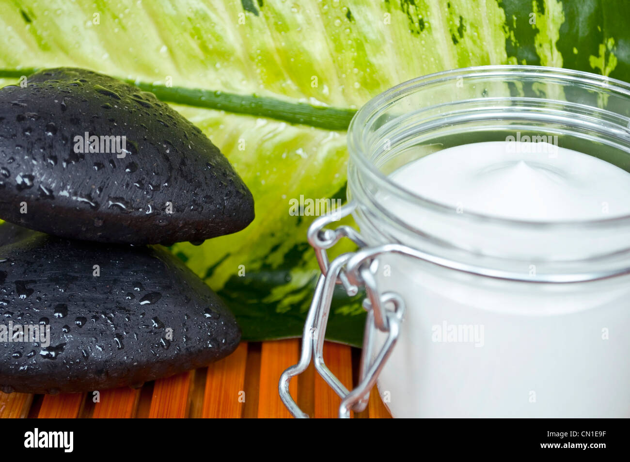 Spa stones and body milk - natural beauty Stock Photo - Alamy