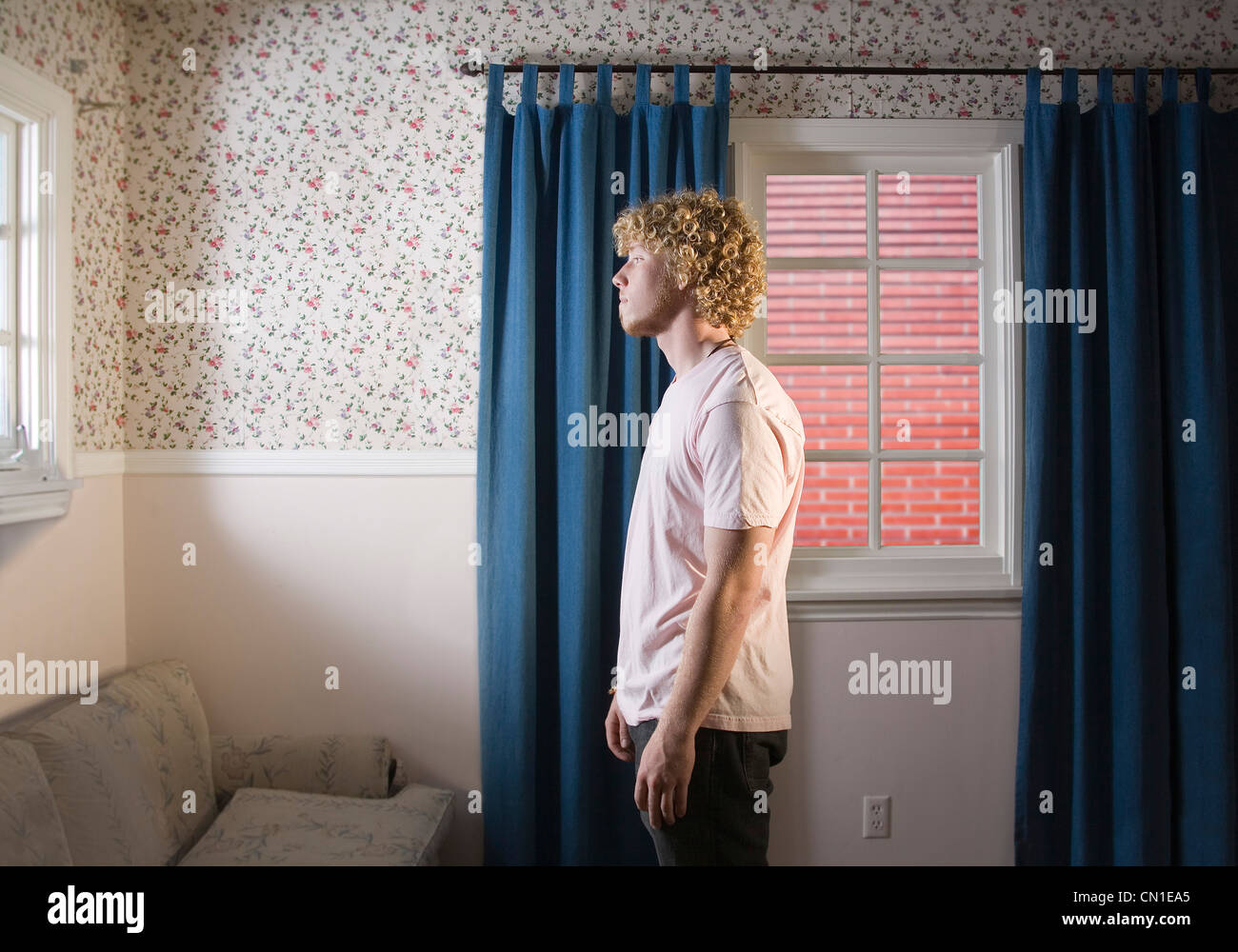 Young Man Looking out Window Stock Photo - Alamy
