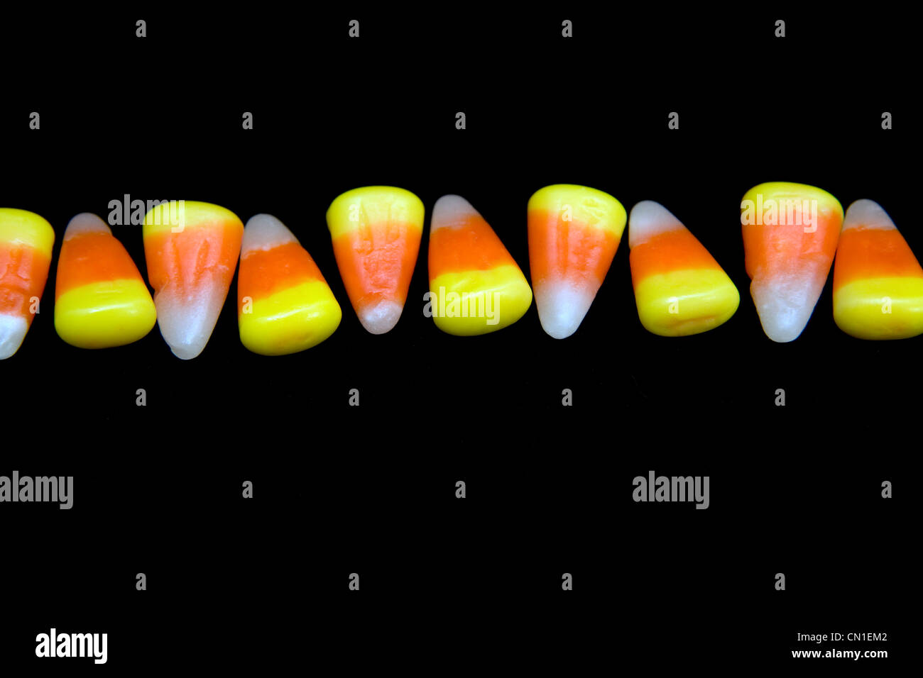 Candy Corn in a Row on Black Background Stock Photo - Alamy
