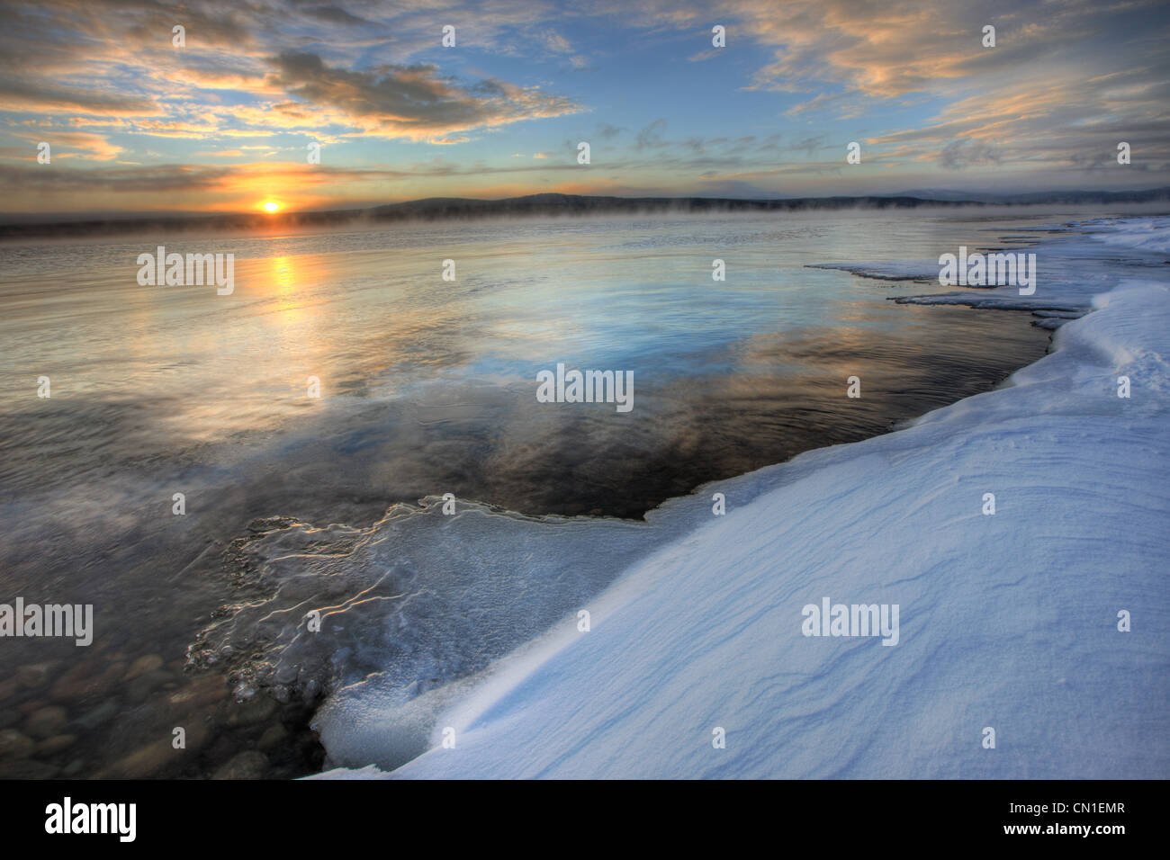 Setting sun over Teslin Lake after a clearing storm, Yukon Stock Photo ...