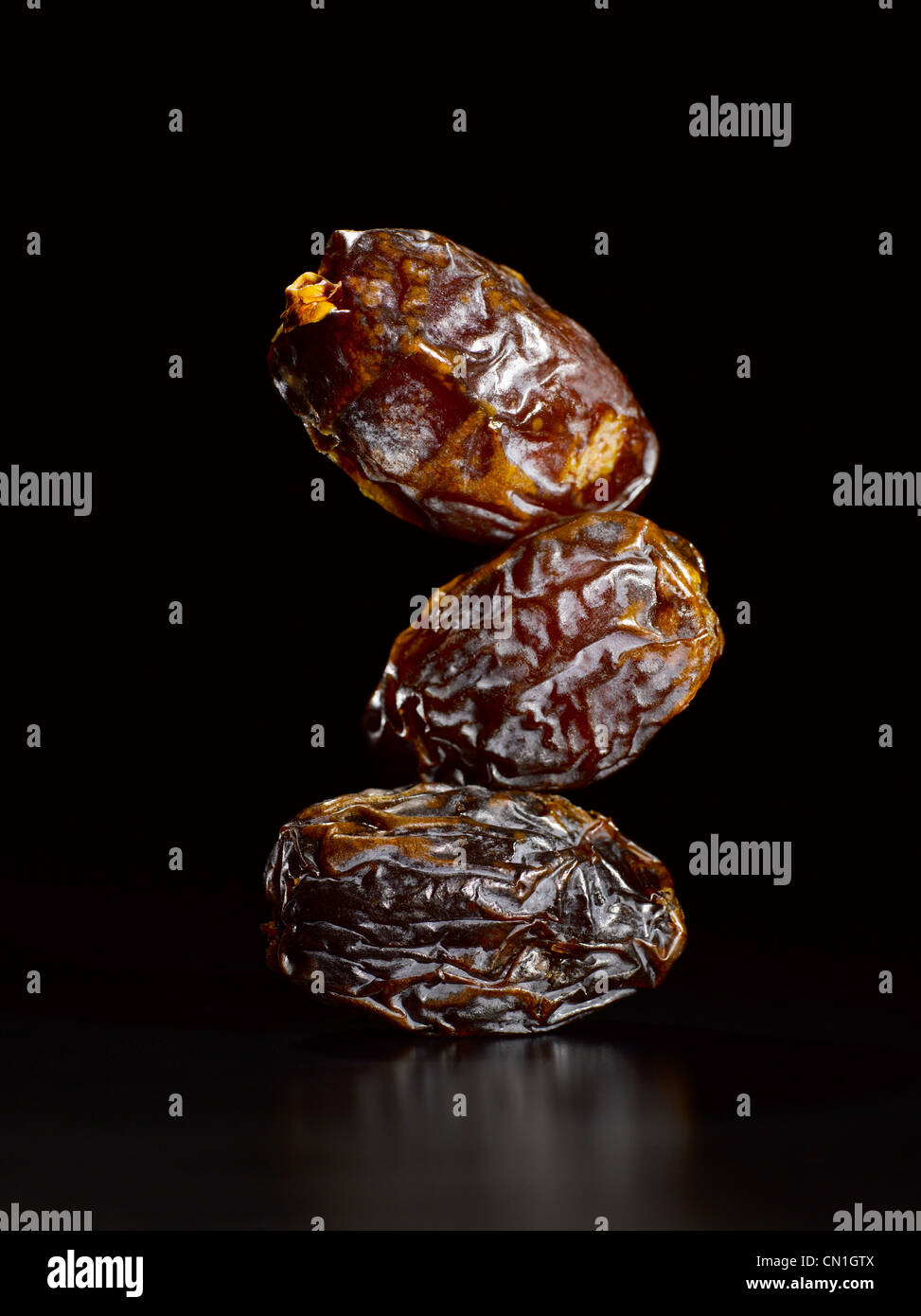 Three Stacked Medjool Dates on Black Background Stock Photo - Alamy