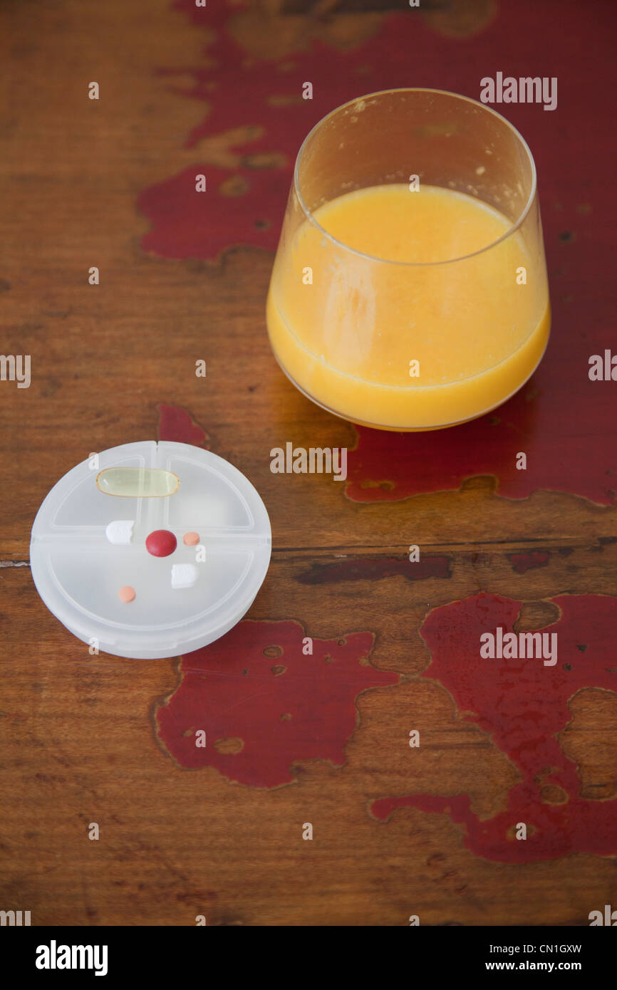 Glass of Orange Juice and Pill Container Stock Photo - Alamy