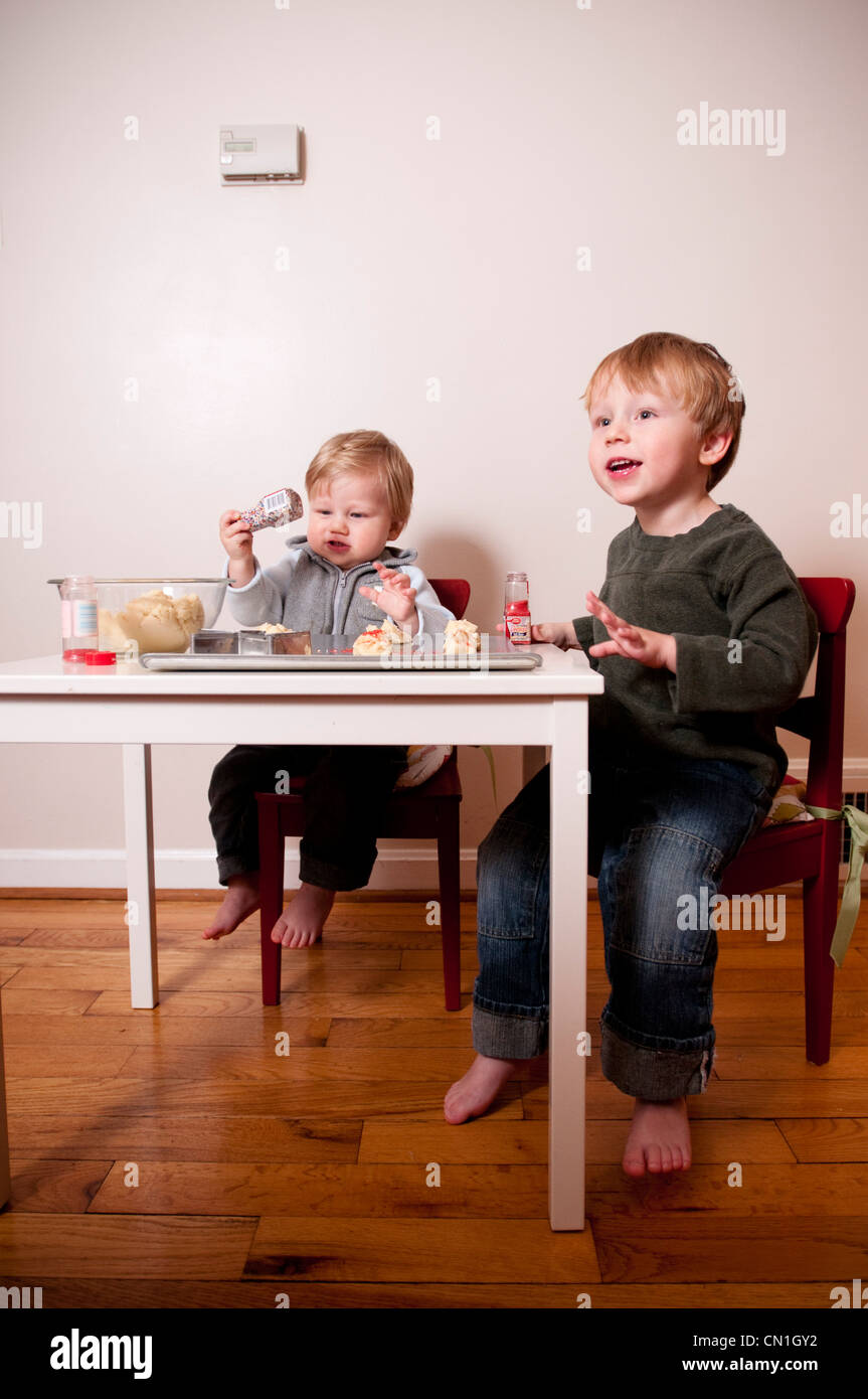 Two Young Boys Making Cookies Stock Photo - Alamy