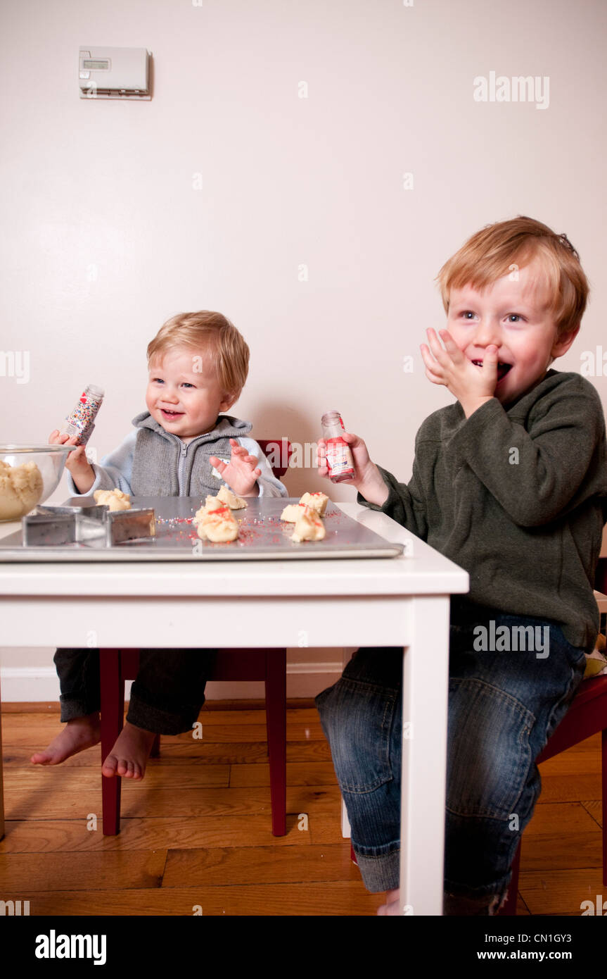 Two Smiling Young Boys Making Cookies Stock Photo - Alamy