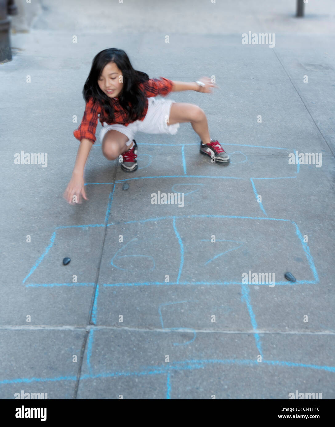 Girl Playing Hopscotch Stock Photo - Alamy