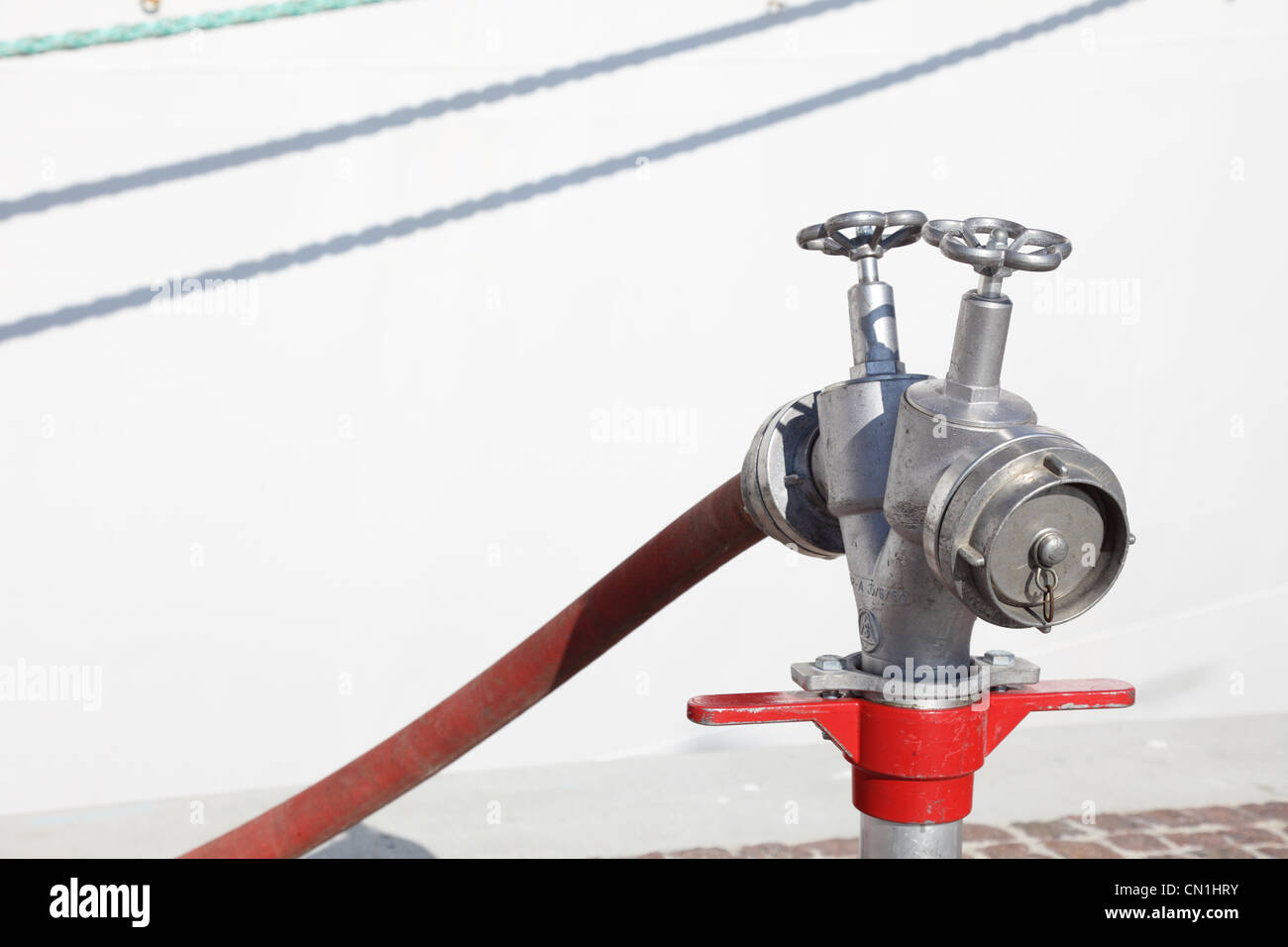 Fire hose snakes from a hydrant Stock Photo - Alamy