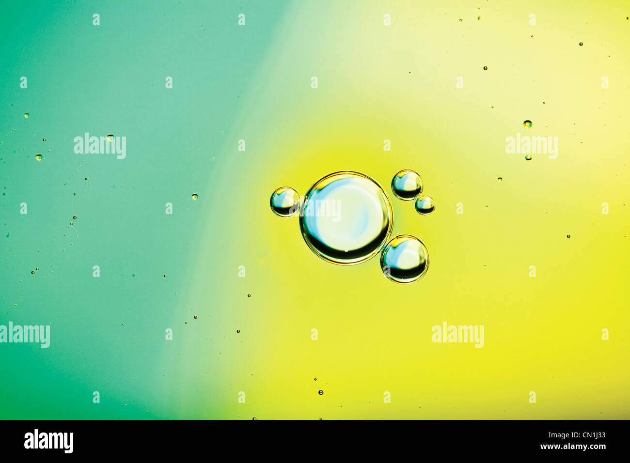 Bubbles in Yellow and Green Liquid Stock Photo - Alamy