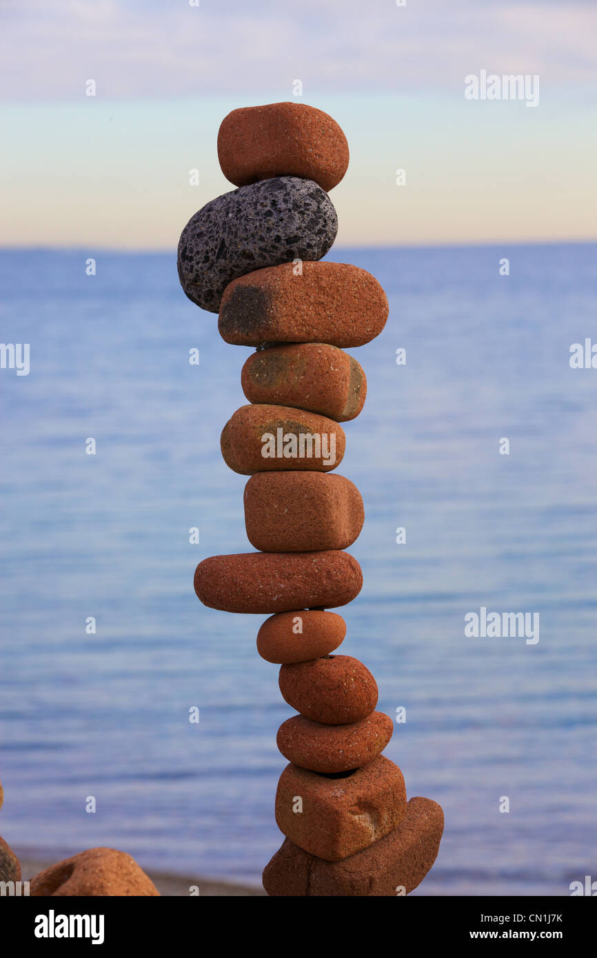 Stones and bricks rounded by the waves are stacked through some re-bar ...