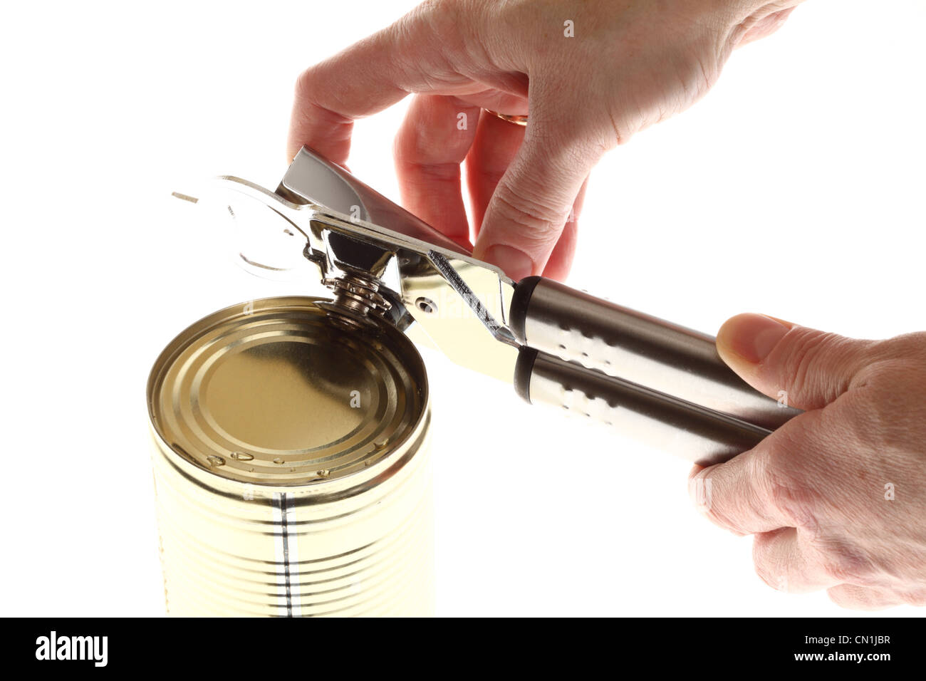 Hand and Tin opener opening a can of food isolated on white Stock Photo ...