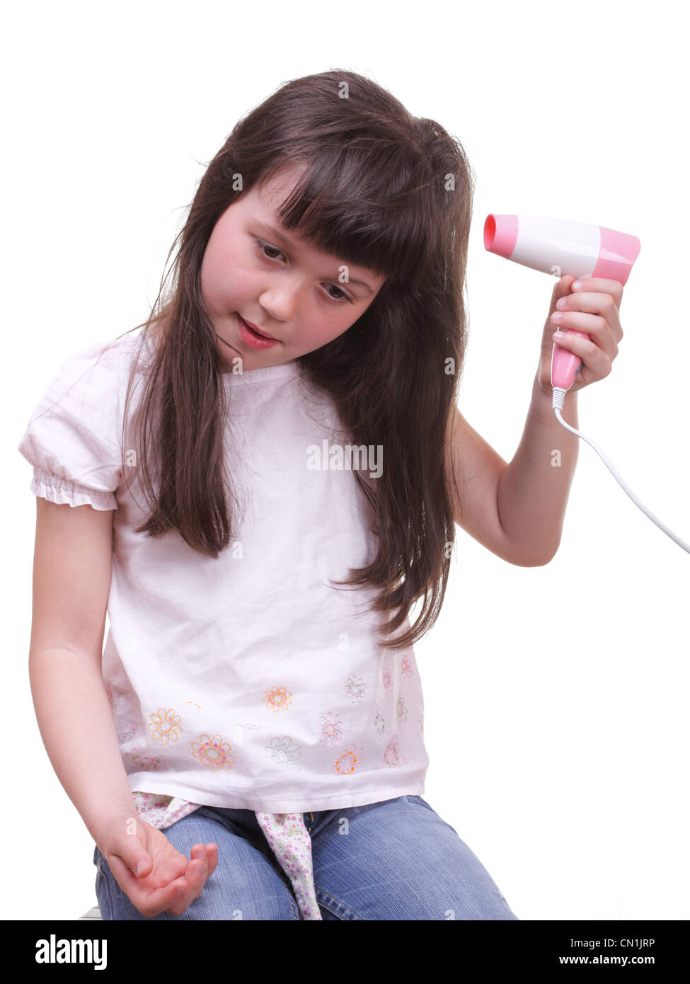 Pretty little girl drying her hair hairdryer isolated on white Stock ...
