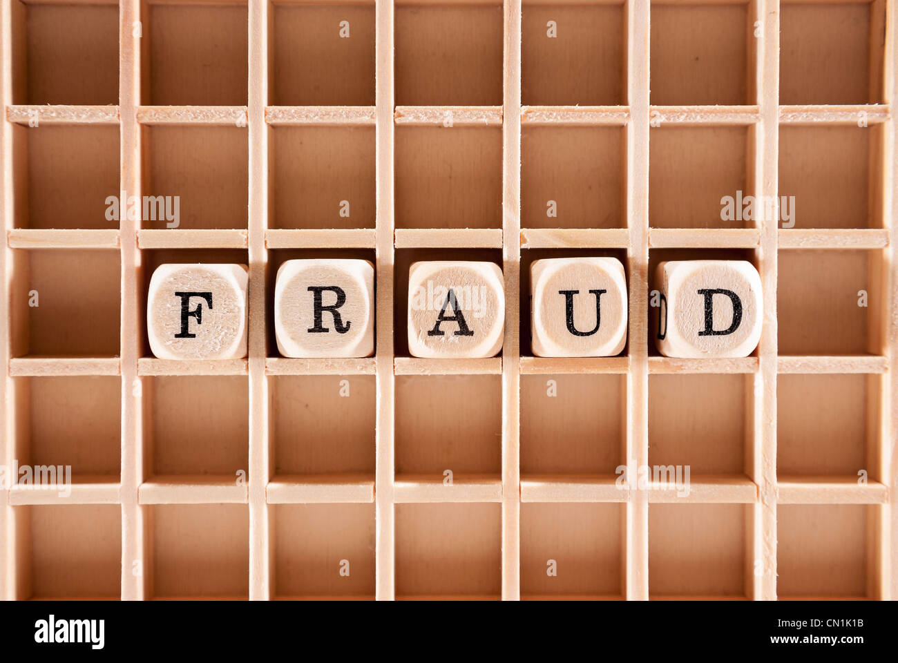 Fraud word construction with letter blocks / cubes and a shallow depth ...