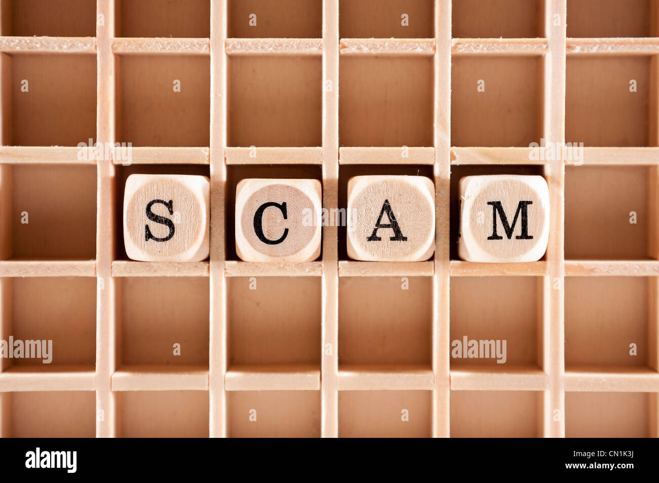 Scam word construction with letter blocks / cubes and a shallow depth ...