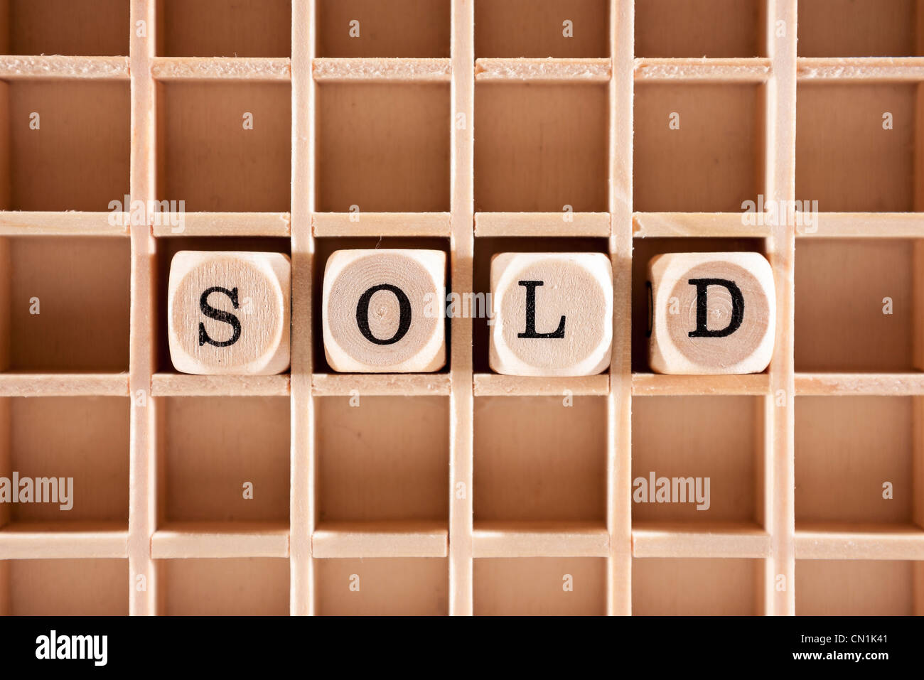 Sold word construction with letter blocks / cubes and a shallow depth ...