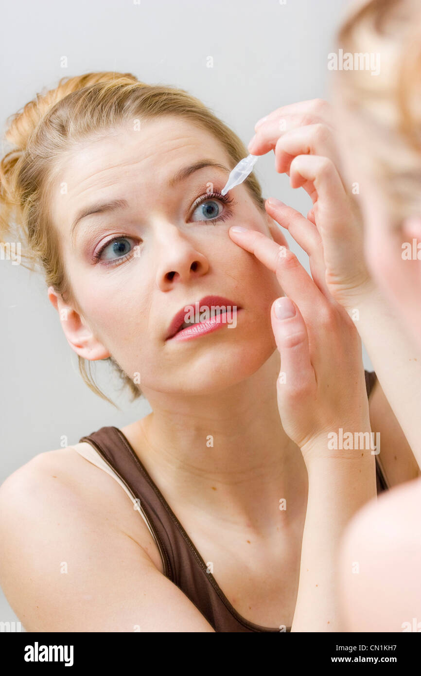 Woman applying eye drops hi-res stock photography and images - Alamy