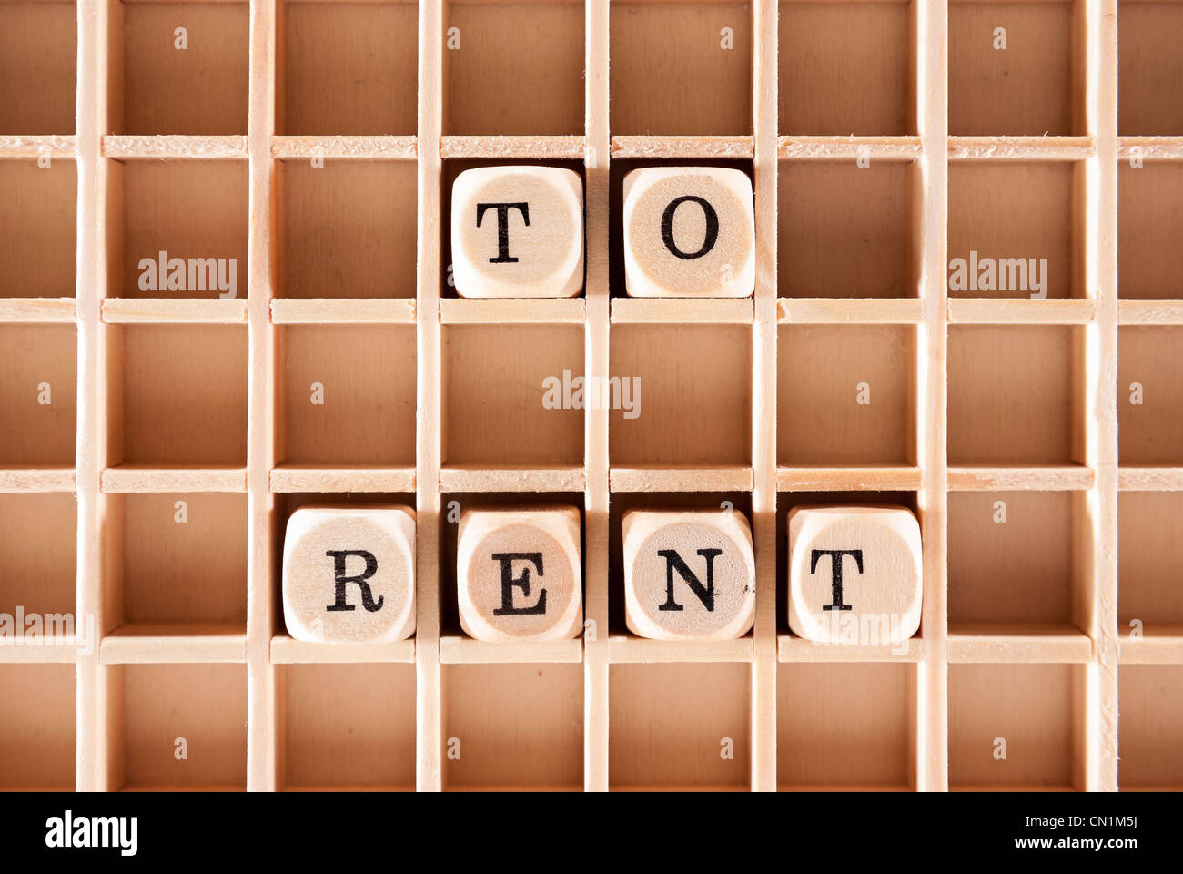 To rent words construction with letter blocks / cubes and a shallow ...