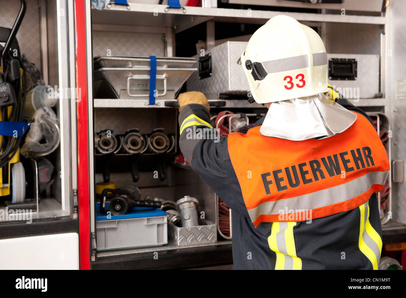 Picture from a young and successful firefighter at work Stock Photo - Alamy