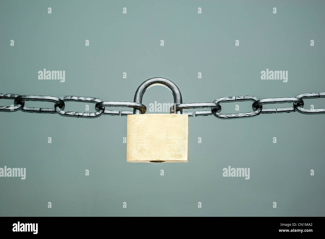 Chains with a key-lock on a dark background Stock Photo - Alamy