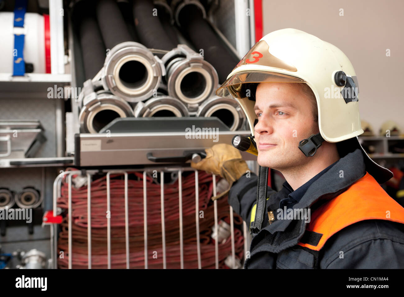 Picture from a young and successful firefighter at work Stock Photo - Alamy